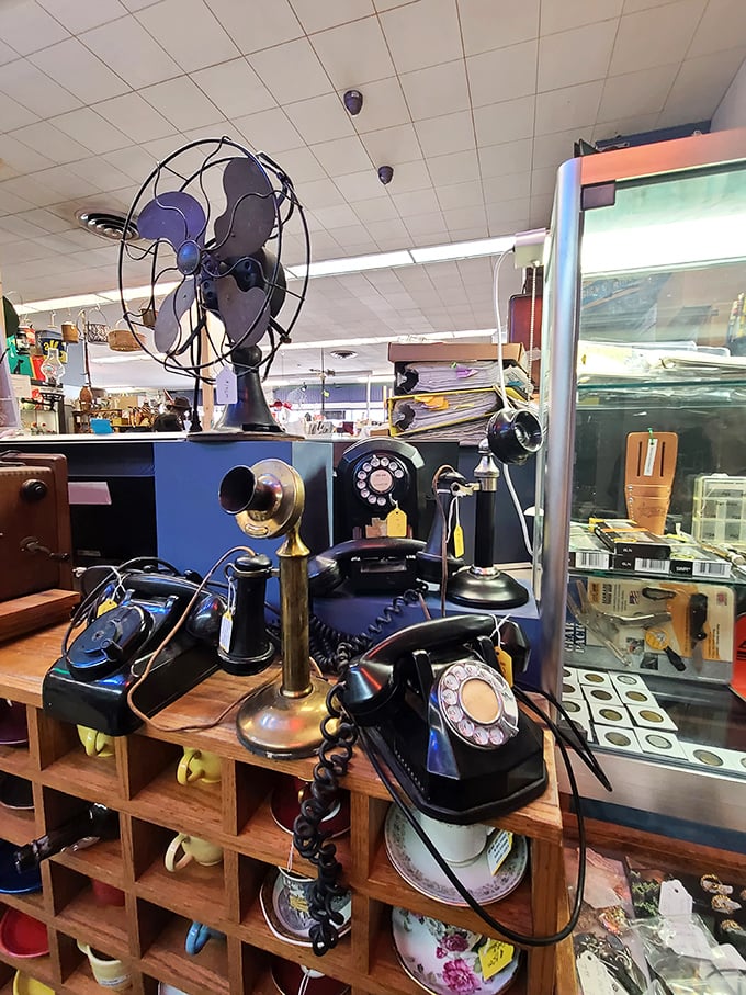 Where rotary phones and vintage tech congregate like old friends at a reunion. That electric fan probably cooled someone during the Dust Bowl!