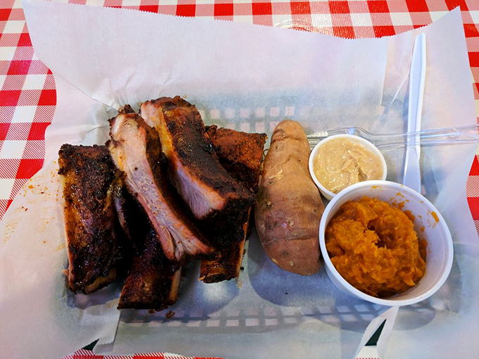 Ribs with that textbook smoke ring and sides that don't play second fiddle. This is barbecue that demands both hands and zero shame.