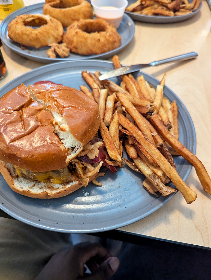 This isn't just a bacon cheeseburger&mdash;it's architecture with purpose. The golden fries standing guard like delicious sentinels.