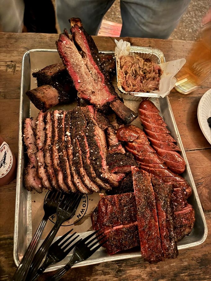Behold the holy trinity of BBQ perfection: brisket with its obsidian bark, a sandwich bursting with possibility, and sides that refuse to be afterthoughts.