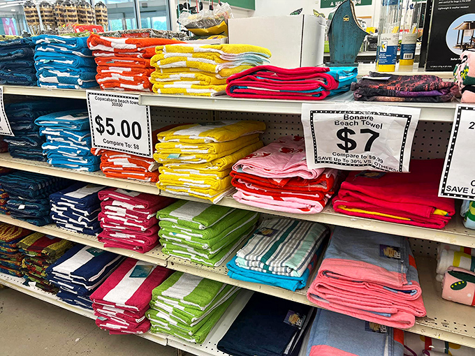 Beach towels in every hue imaginable stand ready for summer adventures. Who knew saving money could look this colorful?