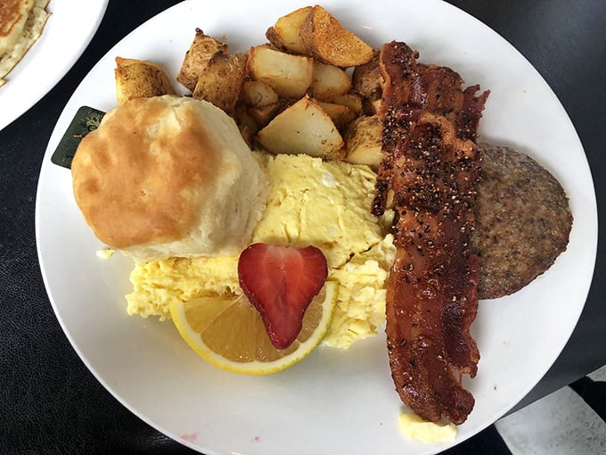 Breakfast architecture at its finest&mdash;a golden biscuit, perfectly scrambled eggs, and bacon that's achieved that magical state between chewy and crisp. The strawberry heart is a delightful touch.