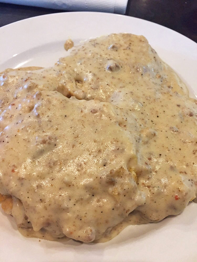 Biscuits and gravy so good they should require a warning label. This pepper-flecked masterpiece isn't just breakfast&mdash;it's an Alabama benediction.