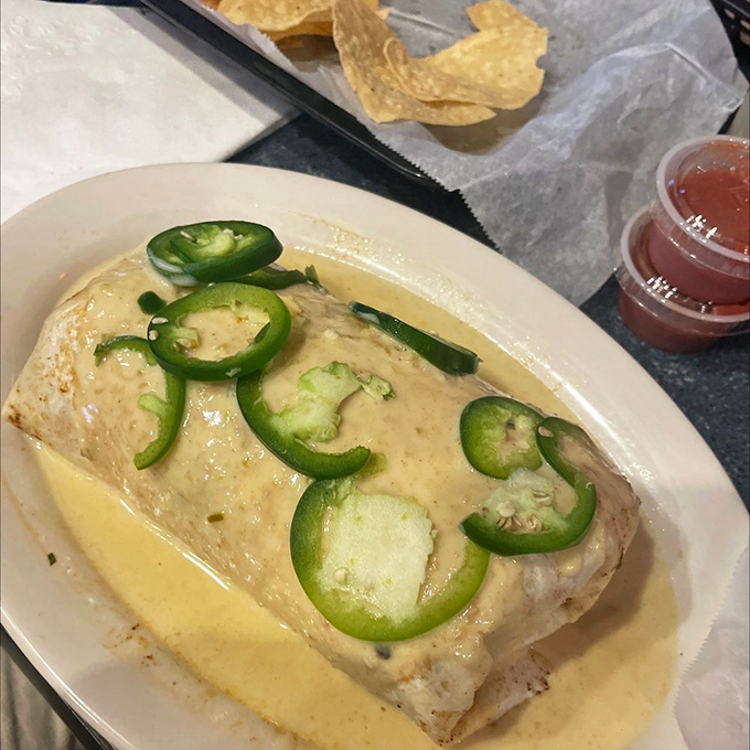 The wet burrito &ndash; where cheese and green chilies perform a duet so harmonious it deserves its own jazz quartet. Those jalape&ntilde;os aren't just garnish; they're exclamation points.