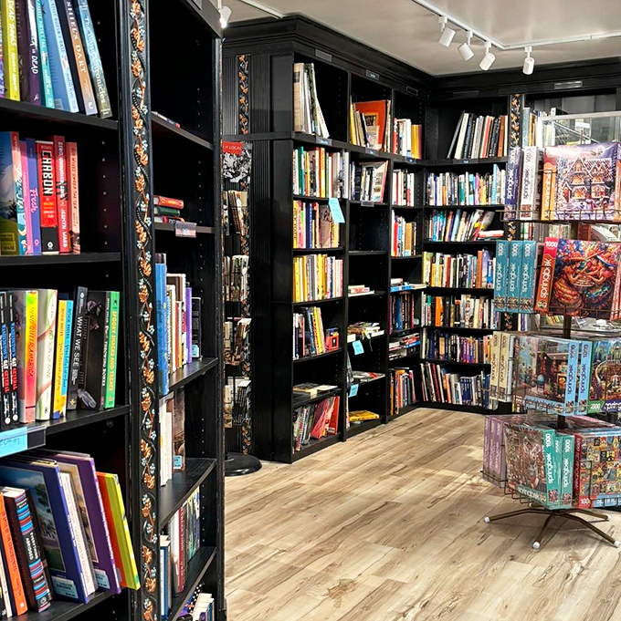 The bibliophile's dream corner&mdash;elegant black shelving houses everything from rare first editions to forgotten bestsellers, proving some treasures don't need to be dusted off.