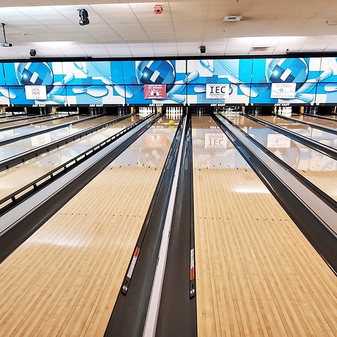 Polished wooden lanes stretch toward their pin targets like runways to fun, each one holding decades of strikes, gutters, and everything between.