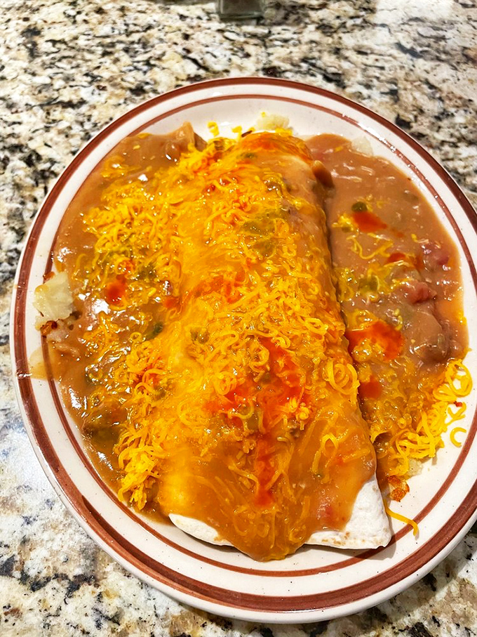 Behold the breakfast burrito in its final form: smothered in green chili and melted cheese, it's Colorado's answer to "What should I eat when I need a hug?"