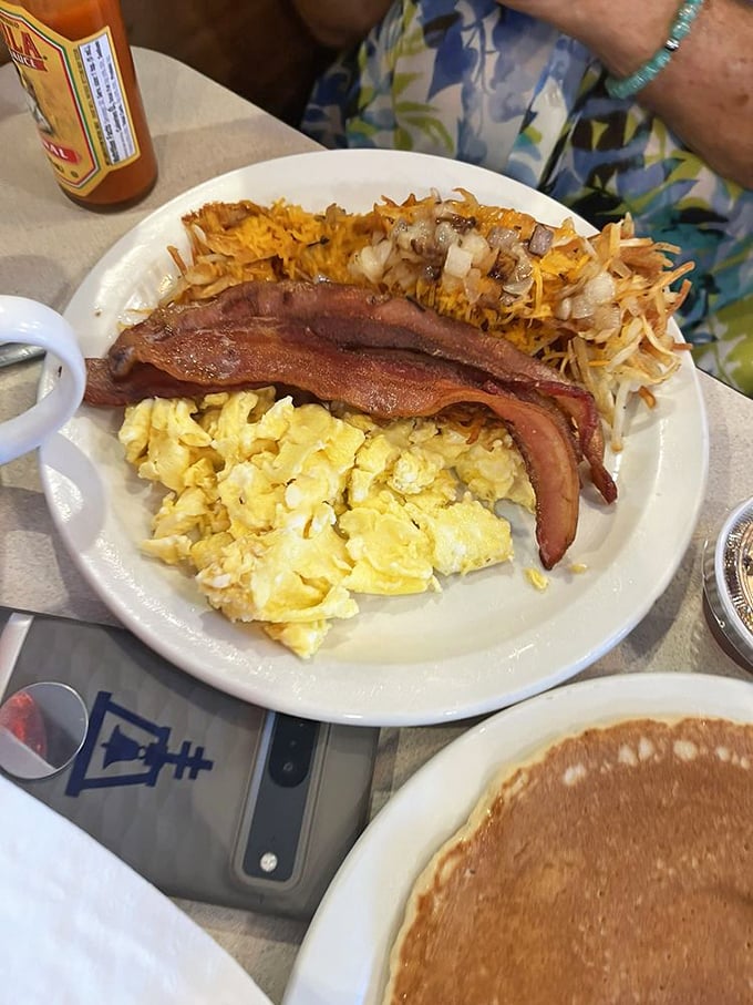 Scrambled eggs so fluffy they could float away if not anchored by perfectly crisped hashbrowns and bacon that means business.