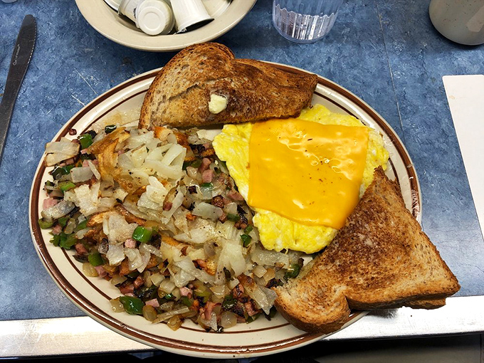 Breakfast nirvana: perfectly golden hash browns, a cheese-draped omelet, and toast that somehow manages to be both crisp and buttery in all the right ways.