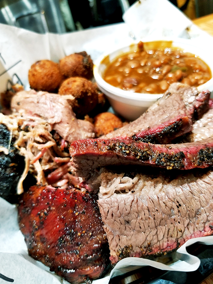 Proof that perfection needs no ceremony. Brisket with that textbook smoke ring and ribs with just the right pull resting beside creamy mac and cheese.