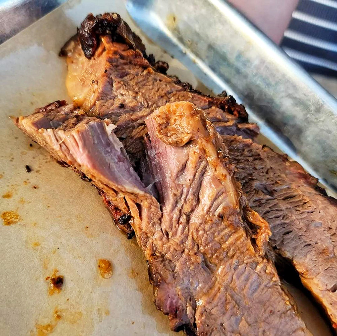 Behold the holy grail of barbecue: brisket with that perfect pink smoke ring. This isn't just meat; it's a religious experience.