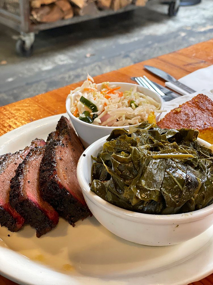 Behold the holy trinity of barbecue bliss: brisket with that coveted smoke ring, sausage with the perfect snap, and sides that refuse to be upstaged.