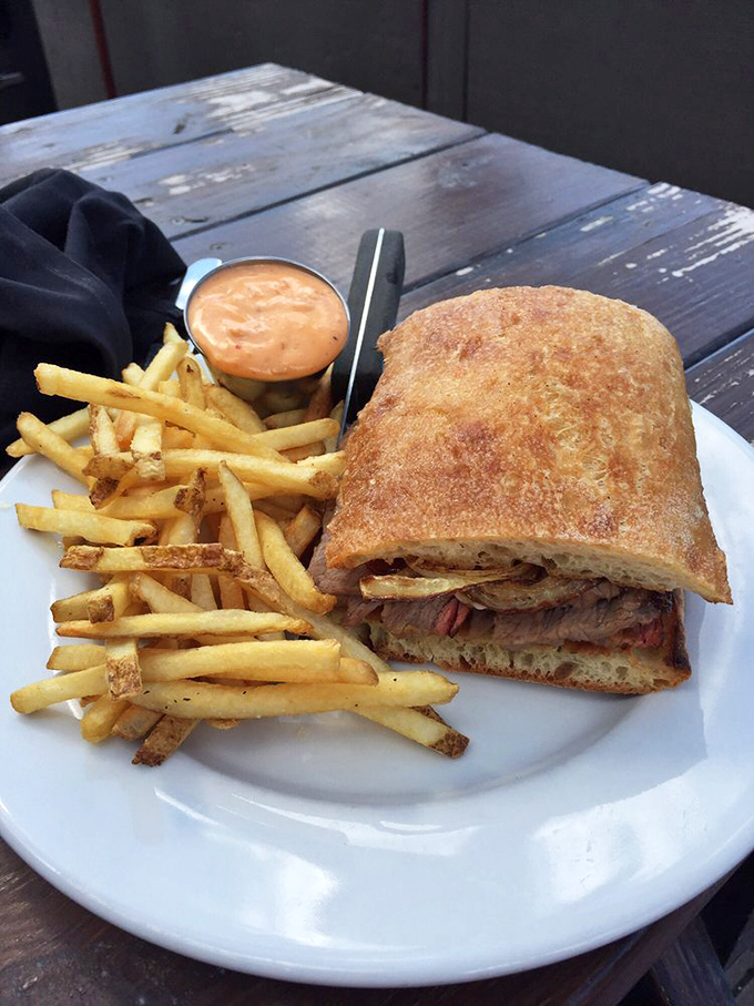 The sandwich that launched a thousand road trips. Golden fries, that signature fry sauce, and a sandwich stuffed with smoky goodness – lunch perfection achieved.
