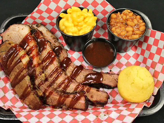 Brisket so perfectly sliced it could make a Texas pitmaster weep with joy, accompanied by mac and cheese that's practically glowing with cheesy goodness.