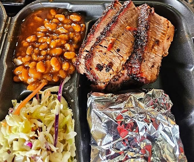 Brisket so perfectly barked, it could teach an old dog new tricks. The beans and slaw aren't sidekicks—they're essential co-stars.