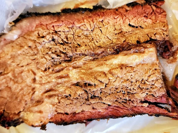 Brisket with a smoke ring so perfect it could win awards, showcasing the telltale pink halo that barbecue aficionados chase.