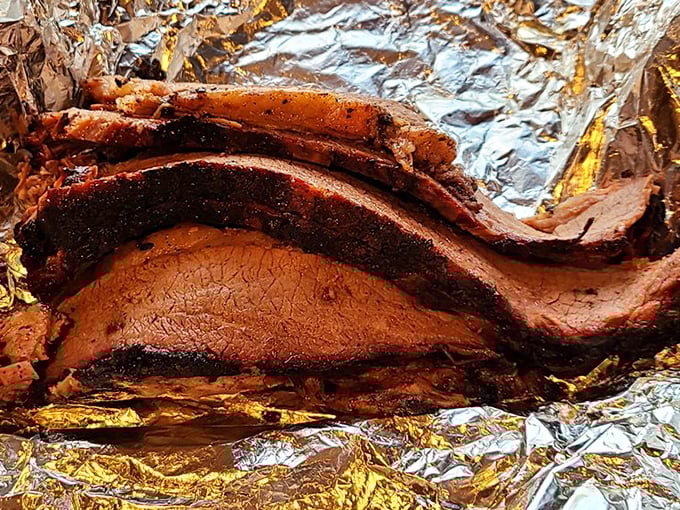Behold the brisket in all its glory! That bark could win architectural awards, while the pink smoke ring whispers secrets of patience and fire.