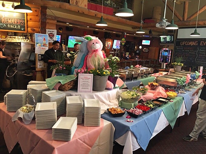 Easter buffet extravaganza! The spread features colorful tablecloths, stacks of plates ready for action, and enough food options to require strategic planning.