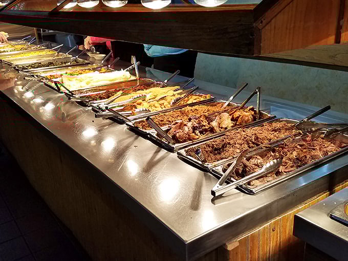 Behold the buffet of dreams! Each tray contains slow-cooked treasures that would make even the most dedicated cardiologist temporarily abandon reason.
