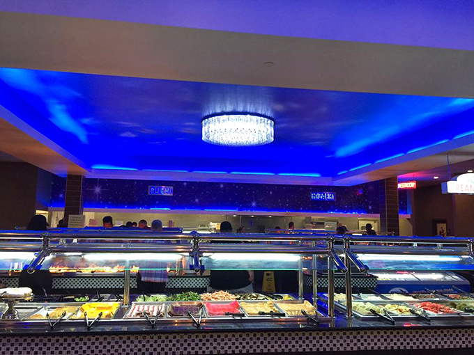 Under the cool blue glow, steam tables stretch into the horizon like a mirage in a hunger-induced desert. This isn't just a buffet—it's a expedition.