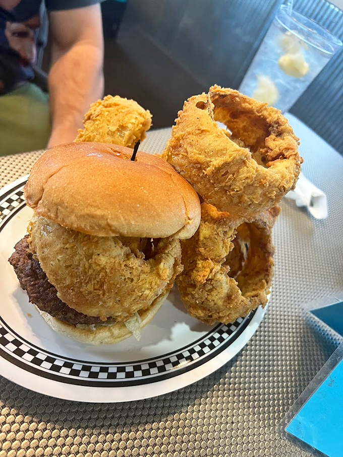 Behold the architectural achievement that is a proper diner burger. Those onion rings aren't just sides&mdash;they're golden halos of crispy perfection.
