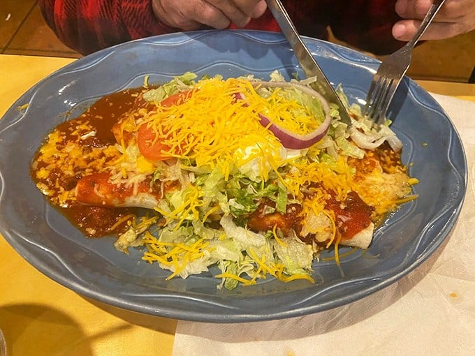 This isn't just dinner; it's an architectural marvel of cheese, lettuce, and sauce that requires both strategy and napkins to conquer.