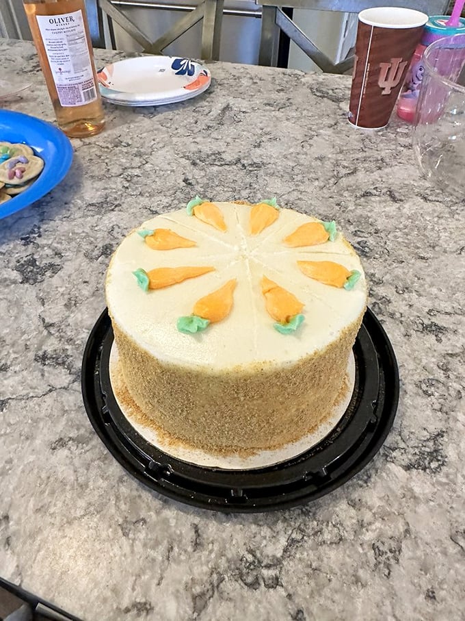 Not just any carrot cake—this is edible architecture with tiny orange carrots standing guard over cream cheese frosting territory worth fighting for.
