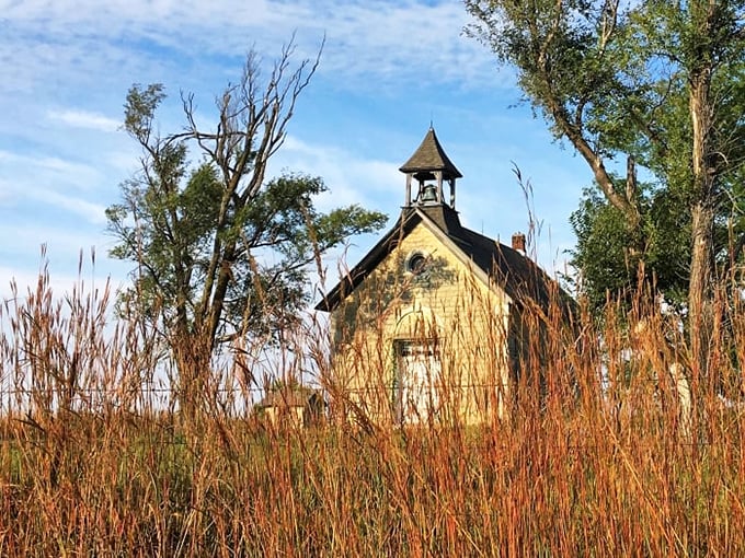This prairie chapel stands as a limestone sentinel, surrounded by tallgrass that whispers stories of pioneers past.