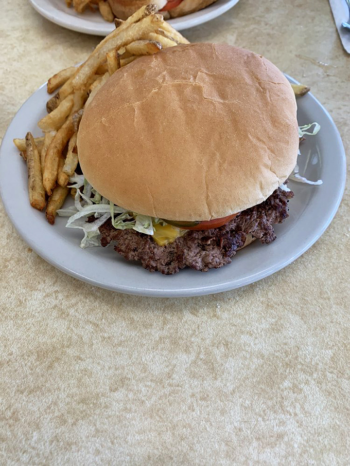 This isn't just a burger—it's edible architecture where the crispy-edged patty foundation supports the perfect ratio of toppings, no structural engineer required.