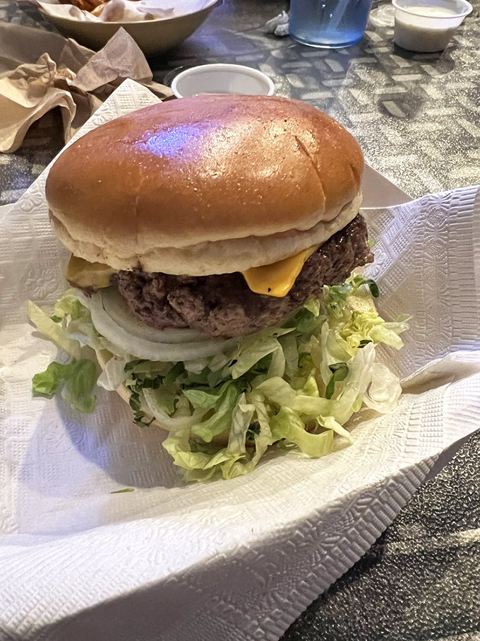 A burger so perfectly constructed it deserves its own architectural award&mdash;the melted cheese cascading down like a yellow waterfall of joy.