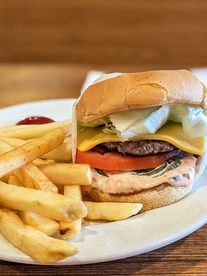This isn't just a cheeseburger; it's edible poetry. The melted American cheese cascades over the patty like a yellow waterfall of happiness.