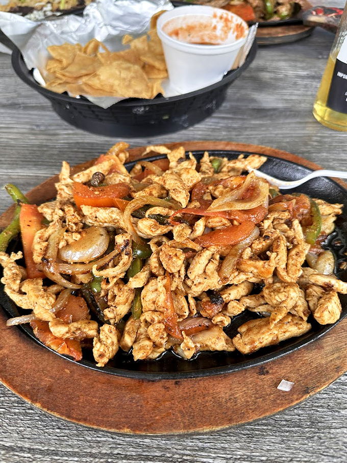 Sizzling chicken fajitas that don't need fancy plating to impress&mdash;just perfectly seasoned strips mingling with caramelized onions and peppers in flavor harmony.