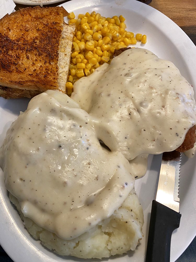 Behold the star attraction: country fried steak swimming in peppery gravy alongside fluffy mashed potatoes. Your diet can start tomorrow.