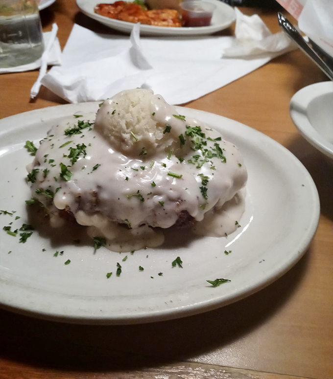 Behold: chicken fried steak nirvana. That cream gravy blanket isn't just topping&mdash;it's practically tucking the meat in for a nap.