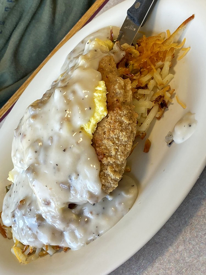 Behold the star attraction: chicken fried steak smothered in peppery country gravy alongside golden hashbrowns. Diets weep while taste buds rejoice.