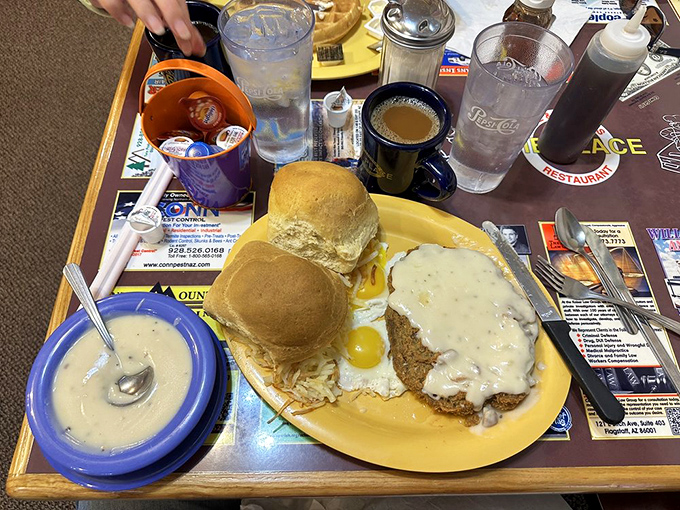 Behold the holy trinity of breakfast: eggs, gravy, and a biscuit that could make your grandmother question her recipe. Comfort food that hugs your soul.