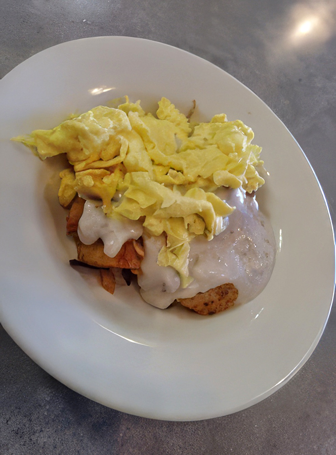 This chicken fried steak with country gravy and scrambled eggs isn't just breakfast – it's edible therapy on a plate.