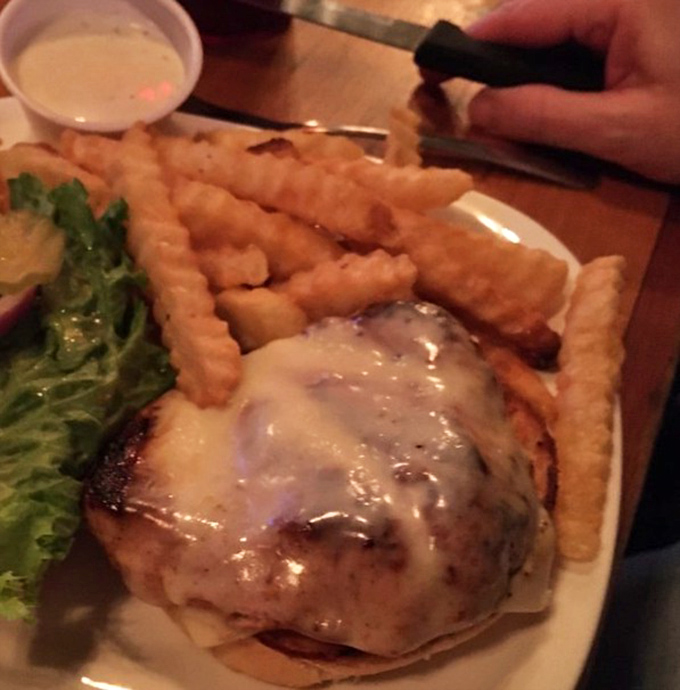 That burger isn't just wearing cheese like a hat&mdash;it's sporting a melty crown while ruling over a kingdom of perfectly crispy fries.
