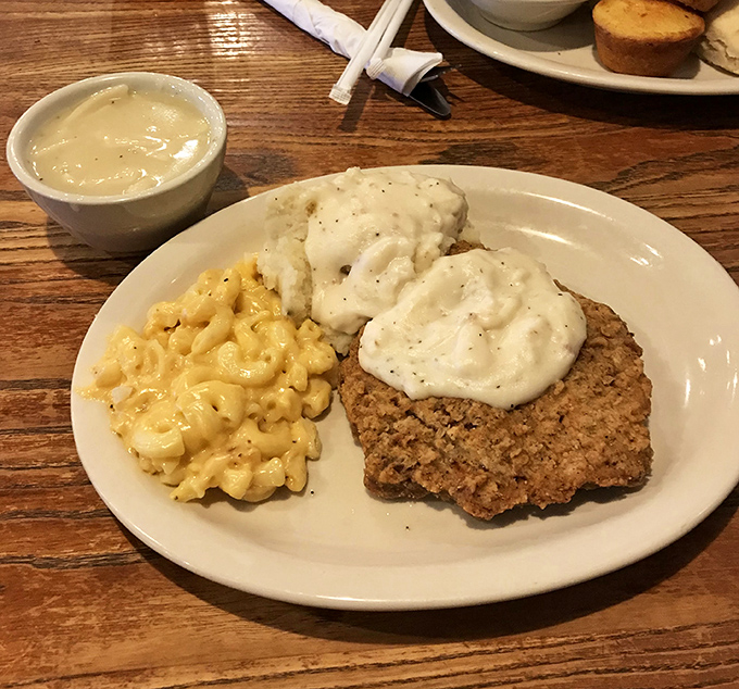 Behold the star of our show! Chicken fried steak wearing its gravy like a velvet robe, with mac and cheese playing the perfect supporting role.