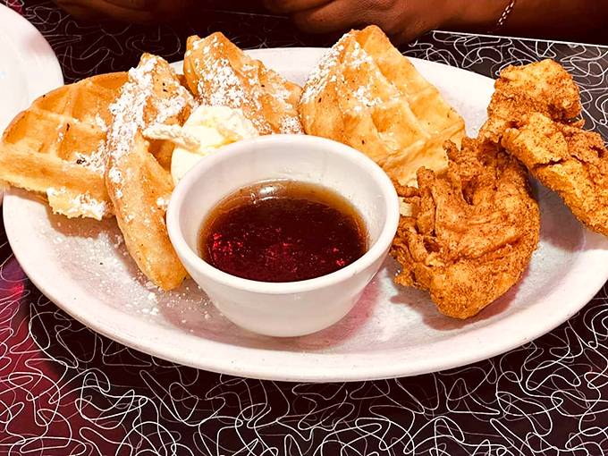 Golden waffles dusted with powdered sugar meet crispy fried chicken&mdash;proof that some of life's greatest pleasures don't need reinvention, just respect.