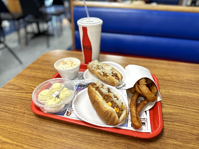 The star of the show: a perfectly split dog nestled in a steamed bun, smothered with that legendary chili sauce and crowned with diced onions.