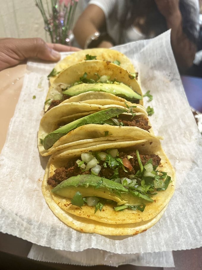 These tacos don't need a LinkedIn profile to prove their credentials - just look at that perfect cilantro-to-meat ratio and those warm, doubled tortillas.