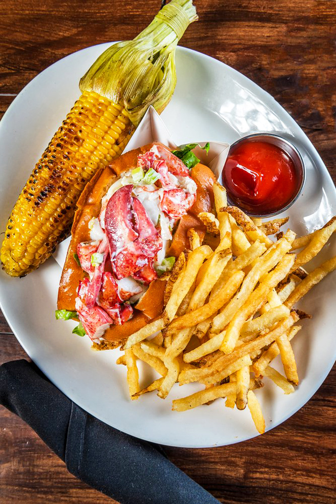This isn't just a lobster roll; it's a vacation on a plate. Sweet chunks of lobster nestled in buttery goodness with crispy fries standing guard.