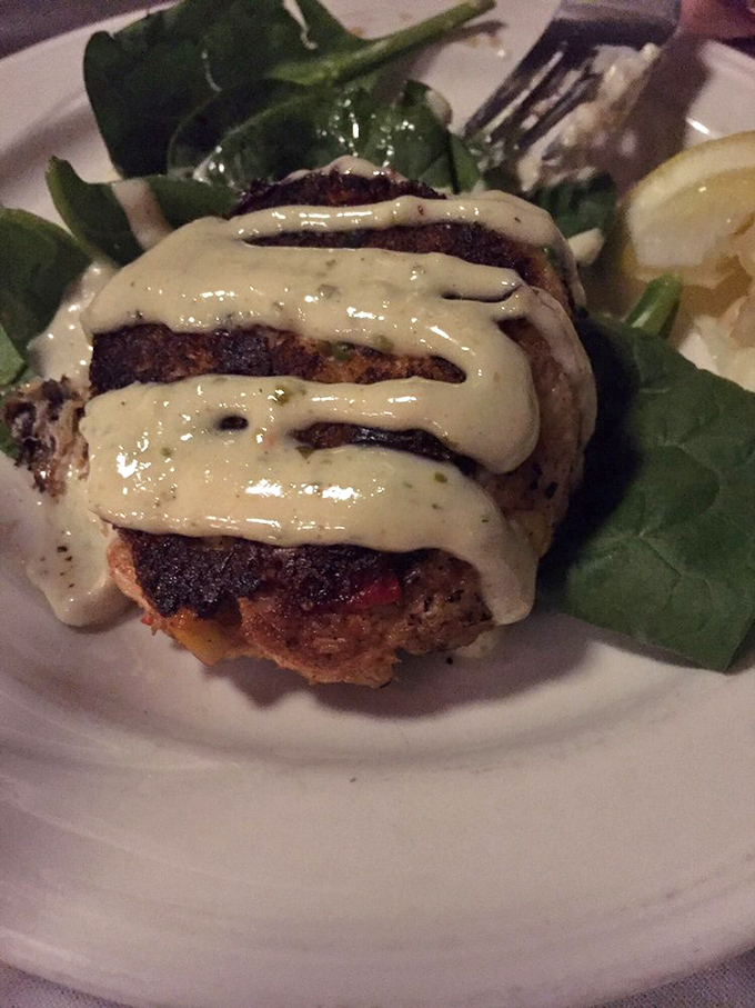 The star of the show: a golden-brown crab cake drizzled with creamy sauce that makes you forget you're 700 miles from the ocean.