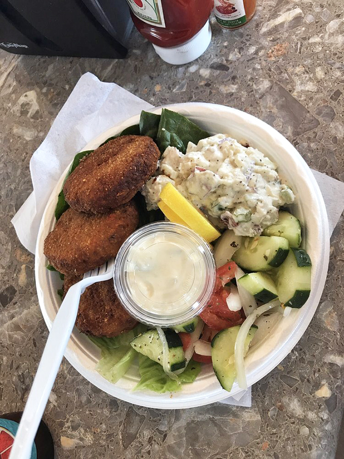 Golden-brown crab cakes that contain more sweet lump crab than should legally fit in something this affordable.