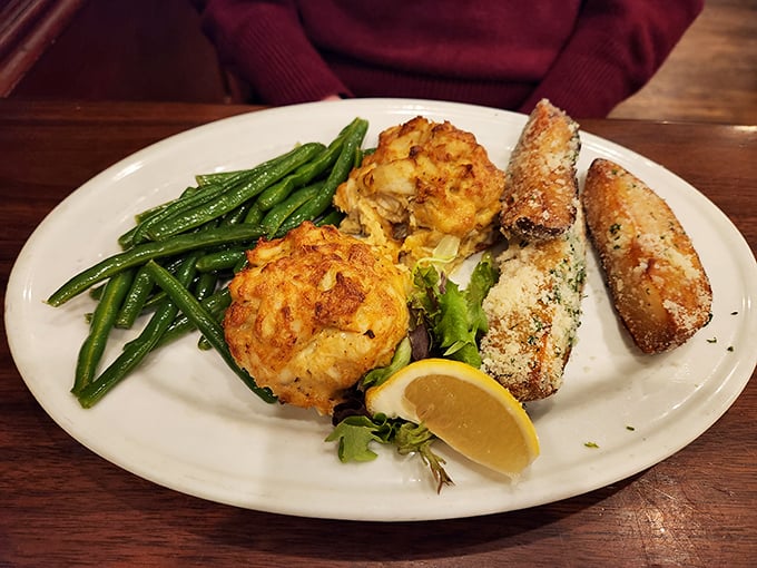 Behold the holy trinity: golden crab cakes, vibrant green beans, and garlic bread. This plate isn't just dinner&mdash;it's Maryland's soul on fine china.