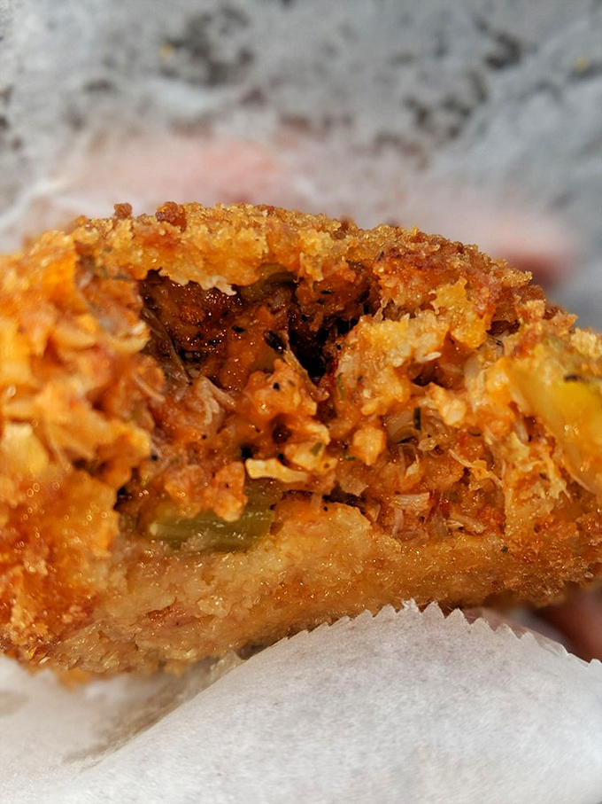 Behold the star attraction&mdash;deviled crab with a golden crust that shatters like delicate glass, revealing spiced treasure within. Food poetry in football form.