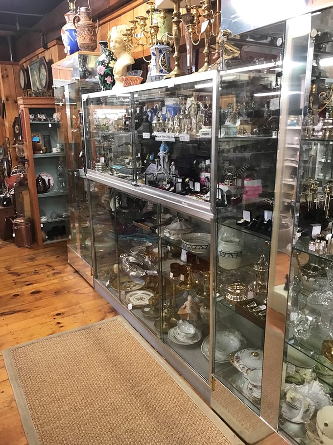 Explore gleaming glass showcases filled with elegant silver, sparkling crystal, and golden treasures that tell stories of a bygone era.