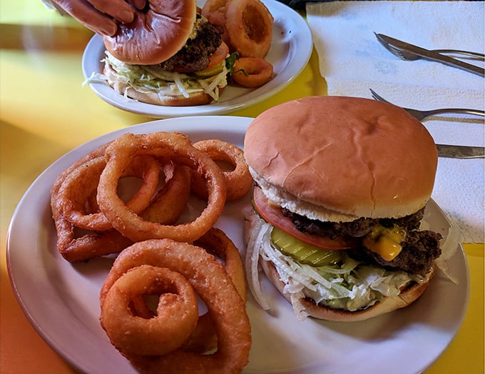 That burger isn't just a meal, it's an event—complete with a supporting cast of golden onion rings that crunch loud enough to turn heads three booths over.