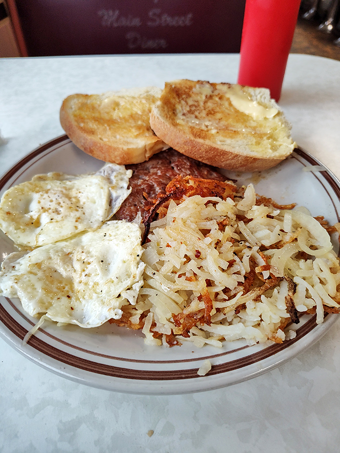 Sunny-side up eggs nestled against crispy hash browns with buttery toast&mdash;the breakfast trinity that's converted more morning skeptics than Sunday sermons.
